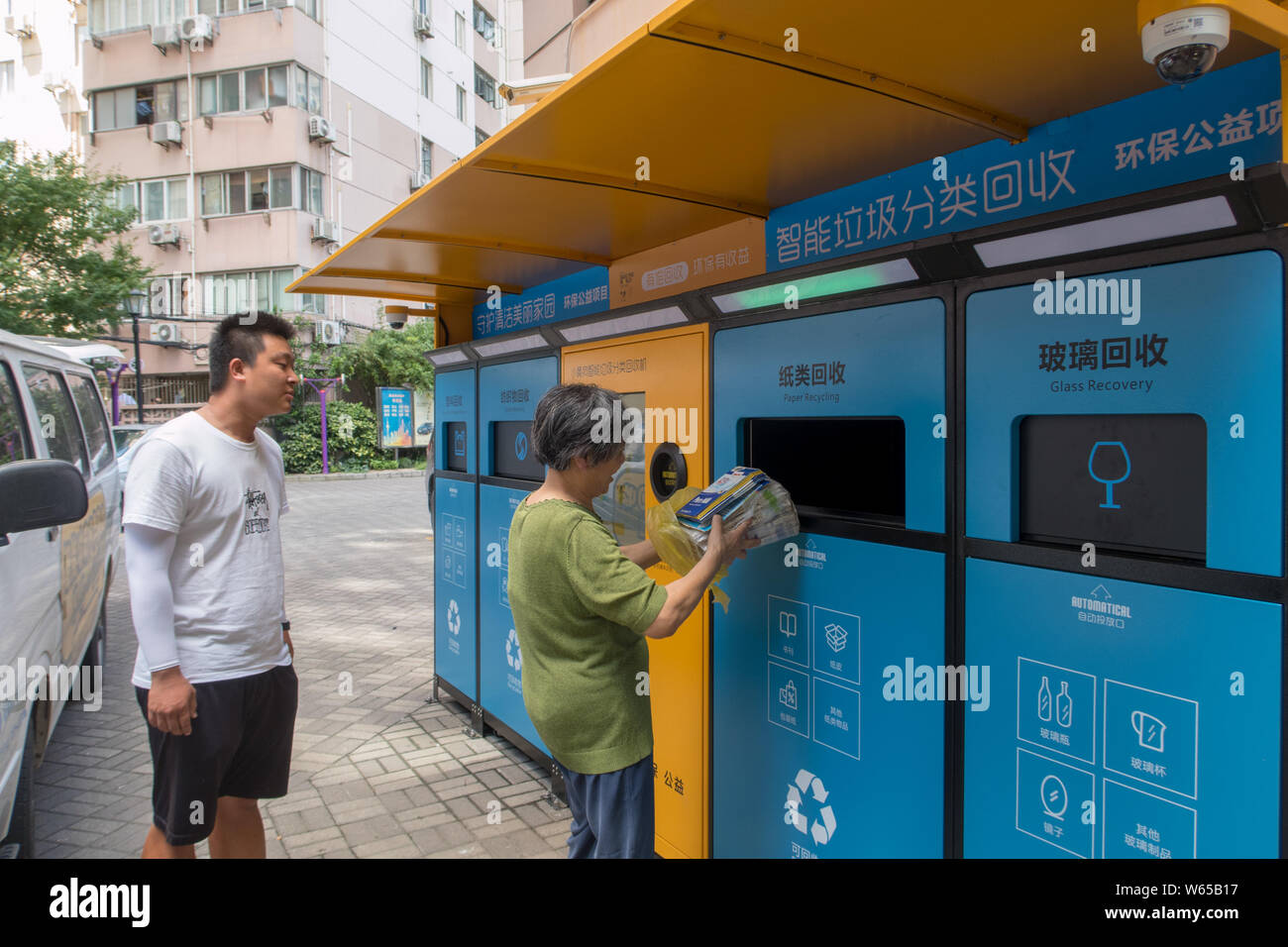 Local residents use a specially-designed sorting machine supported by ...