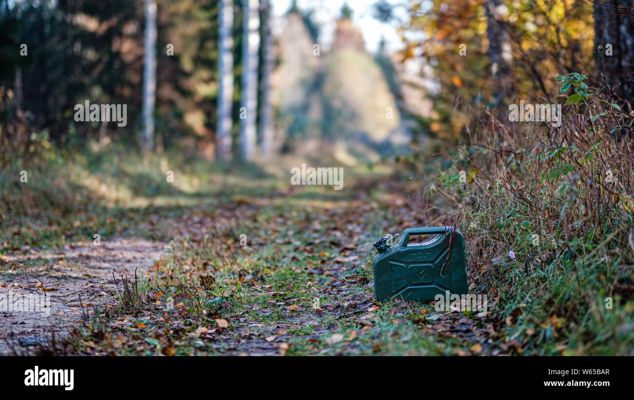 green can of gas on the forest road. need to refuel Stock Photo - Alamy