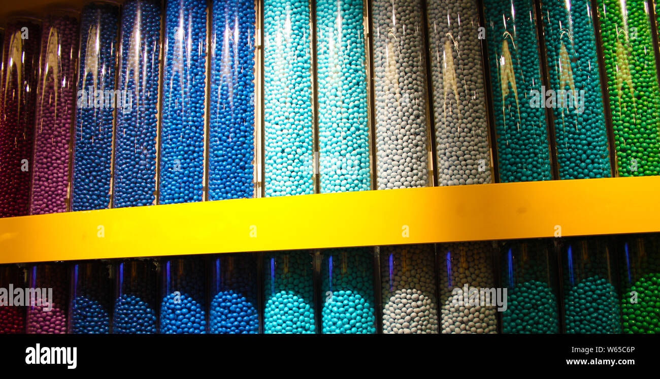 many chocolates of colored smarties of different types and sugars ...