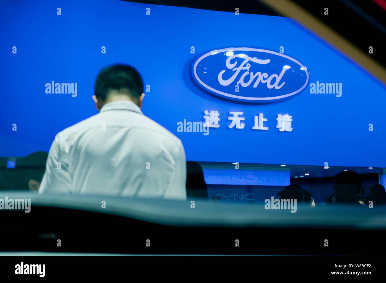 --FILE--A Chinese employee is pictured at the stand of Ford during the ...