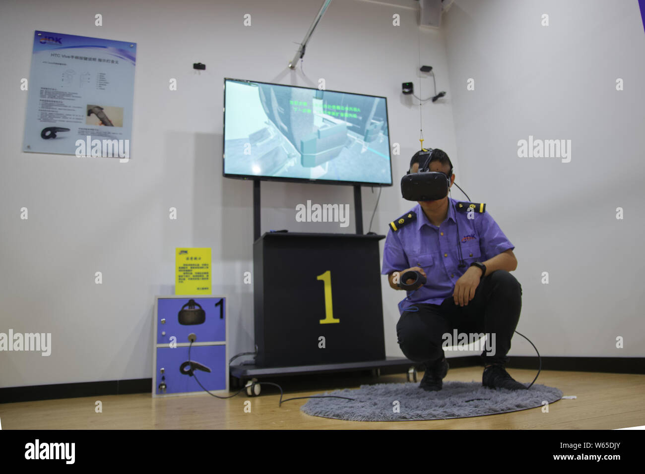 A Chinese worker tries out a VR device to check a "Fuxing" high-speed ...