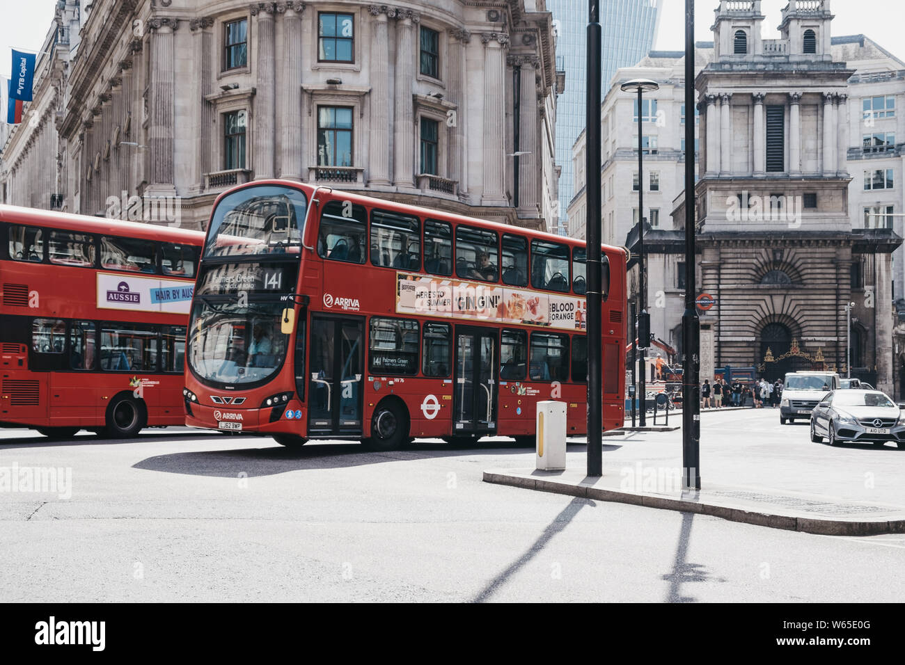 London, UK - July 29, 2019: Red double decker buses on a road by the ...