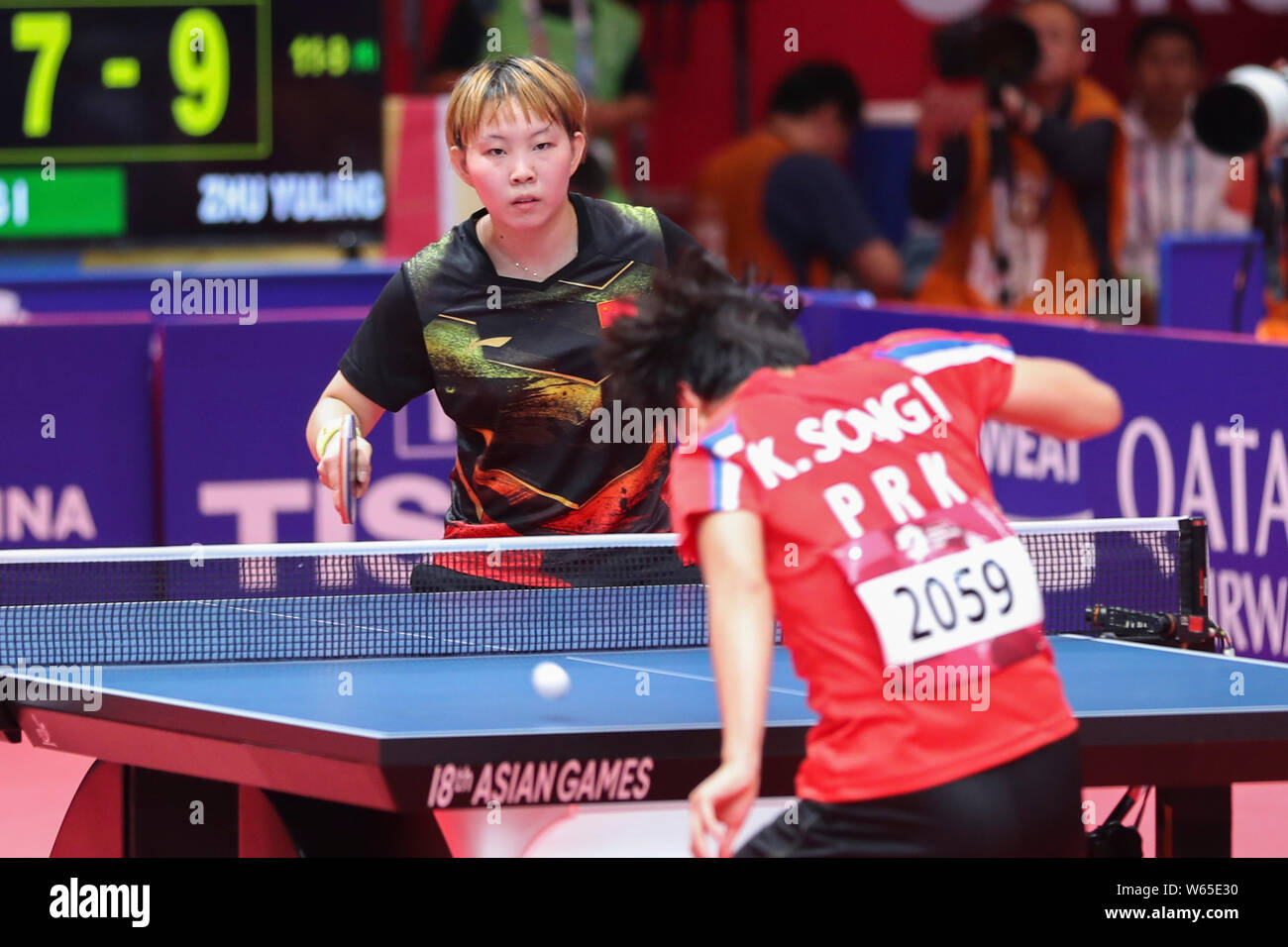 Zhu Yuling of China, back, prepares to return a shot to Kim Song-i of ...