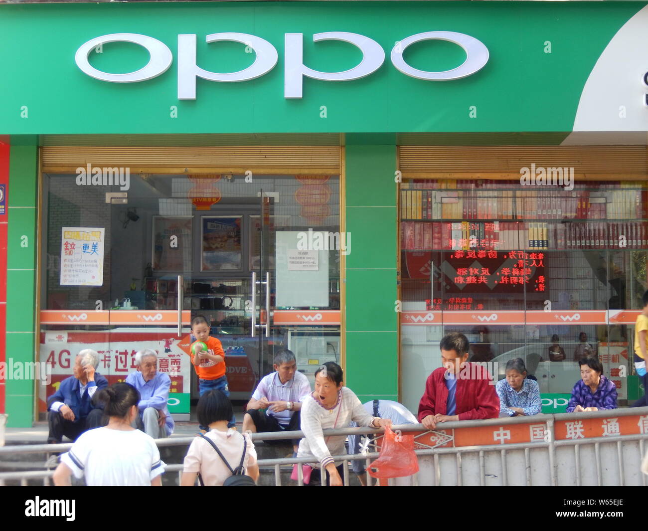 --FILE--Pedestrians walk past a store of OPPO in Yunyang county, Chongqing, China, 24 April 2017 ...