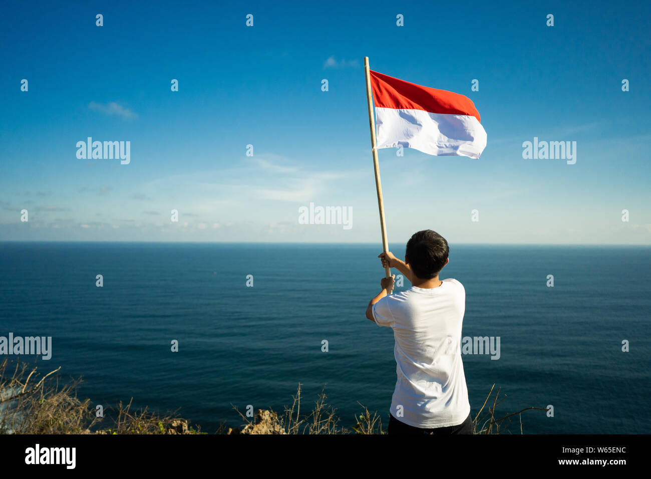 man with indonesian flag of indonesia on top of the mountain Stock ...
