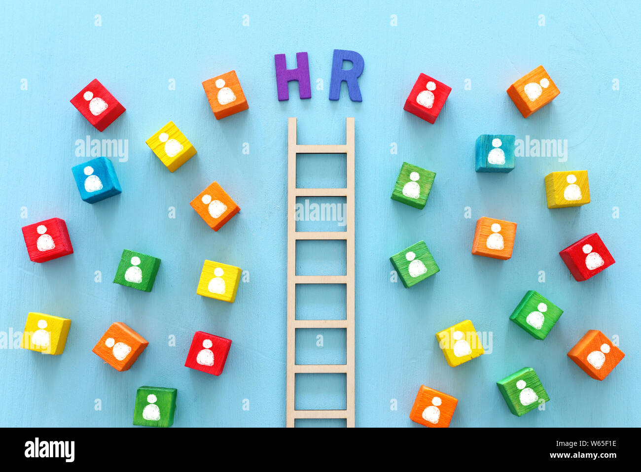 Business image of wooden ladder with people icons over blue table ...