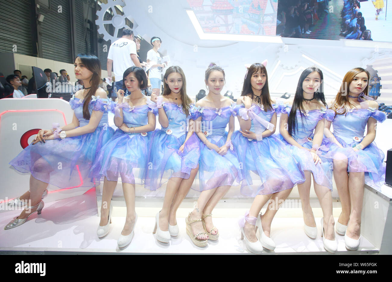 Chinese showgirls pose at the stand of Shanda Games during the 16th ...