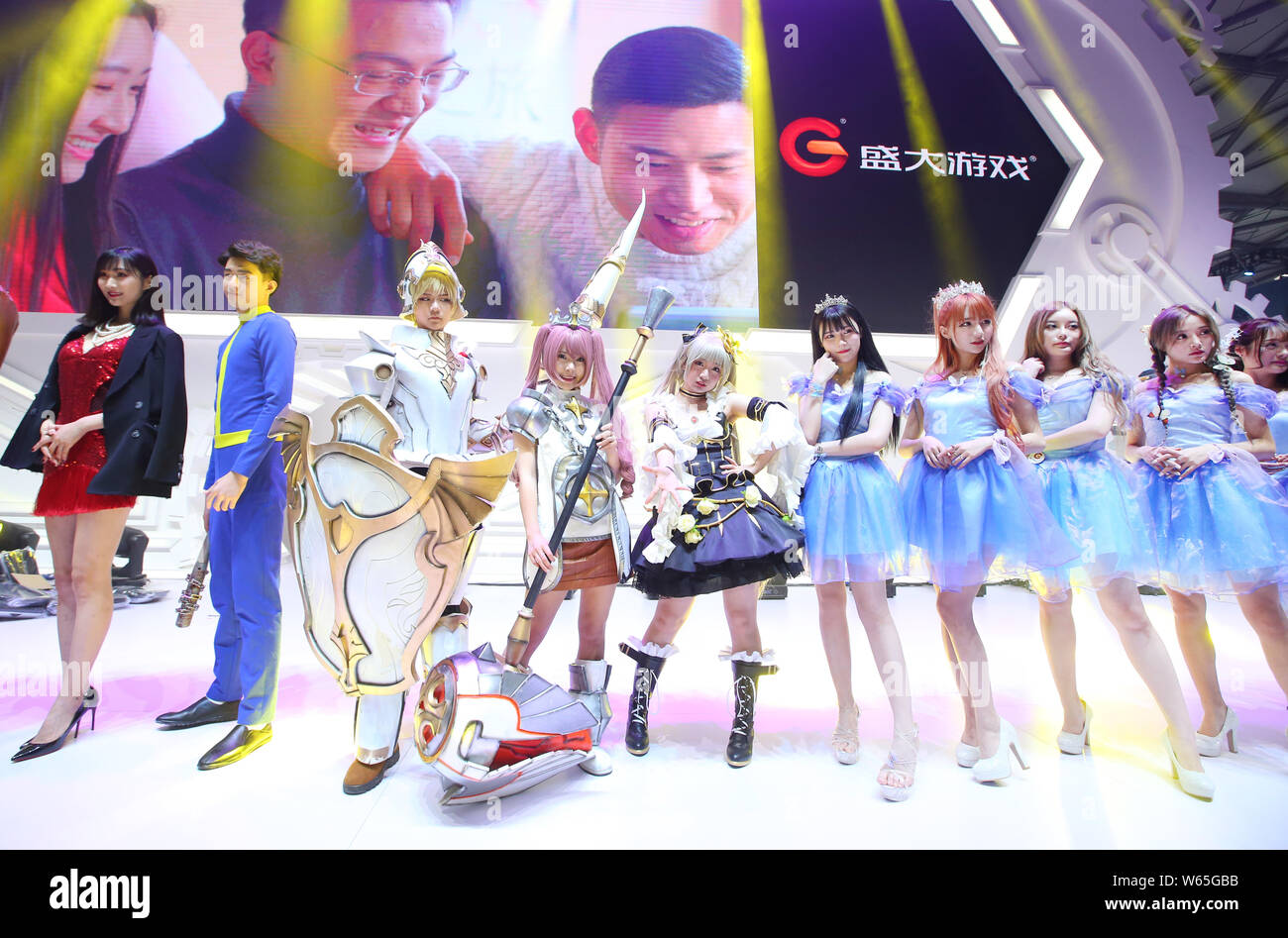 Chinese showgirls pose at the stand of Shanda Games during the 16th ...