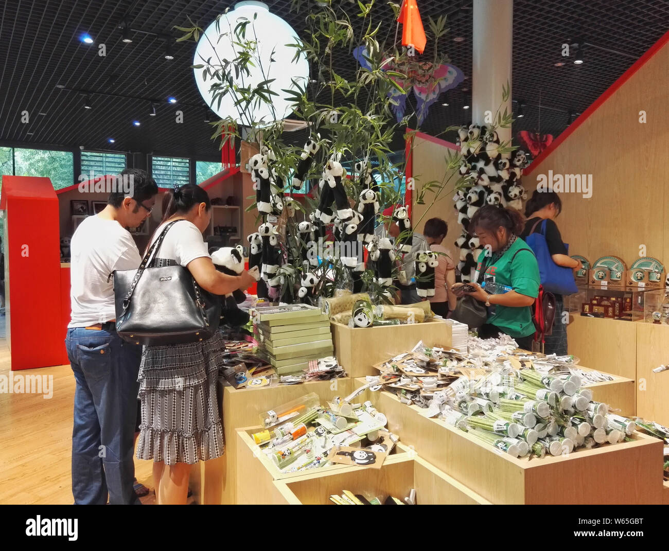 Customers choose panda-themed souvenirs at the Giant Panda House Shop ...