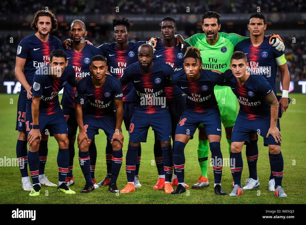 Players of the starting line-up of Paris Saint-Germain pose for photos ...