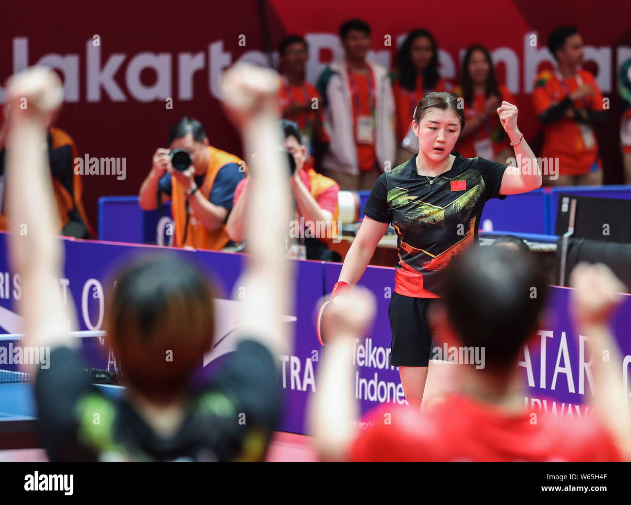 Chen Meng of China, back, celebrates with her teammates after defeating ...