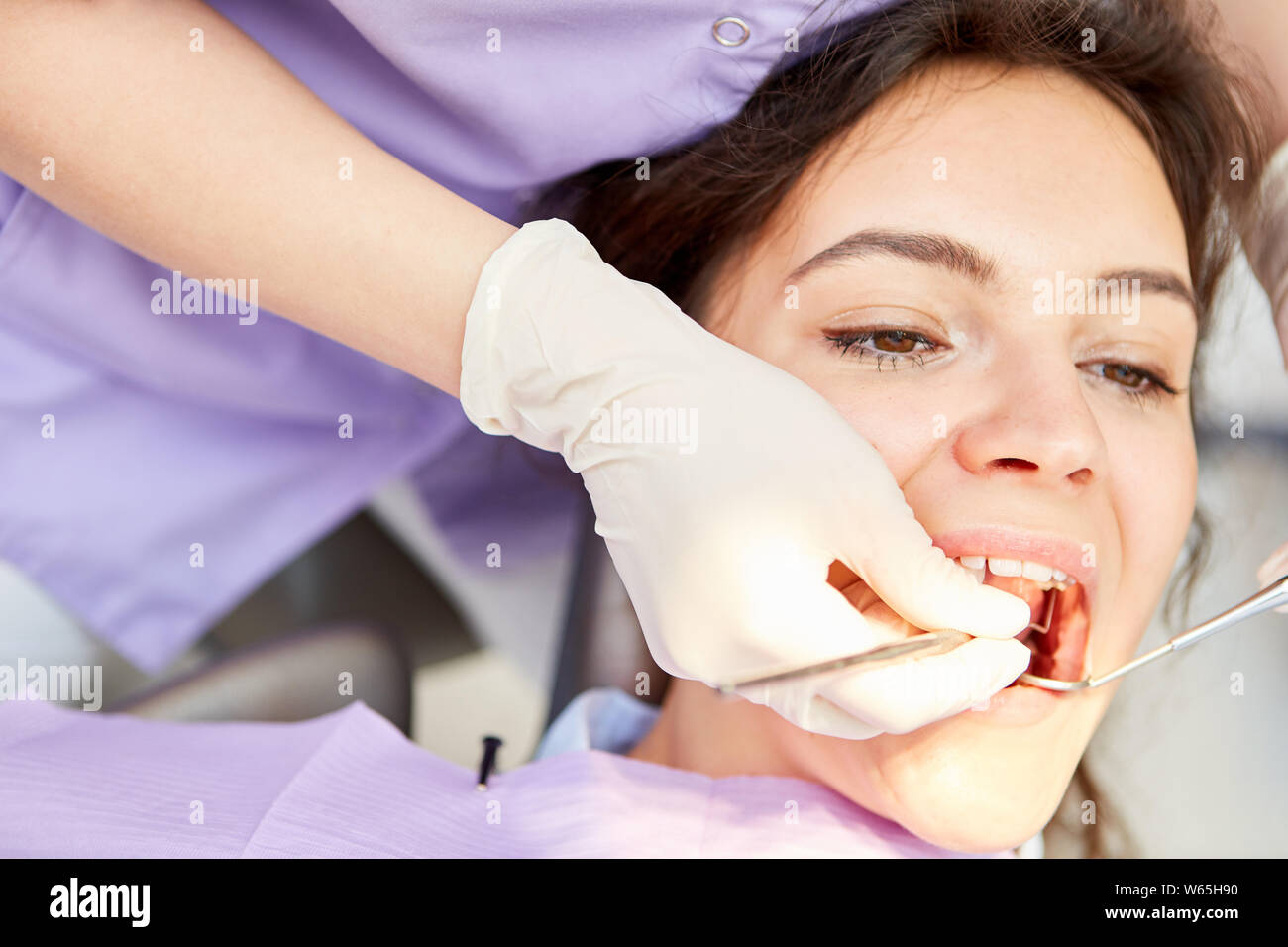 Dentist makes a caries check-up on patient with hand instruments Stock ...