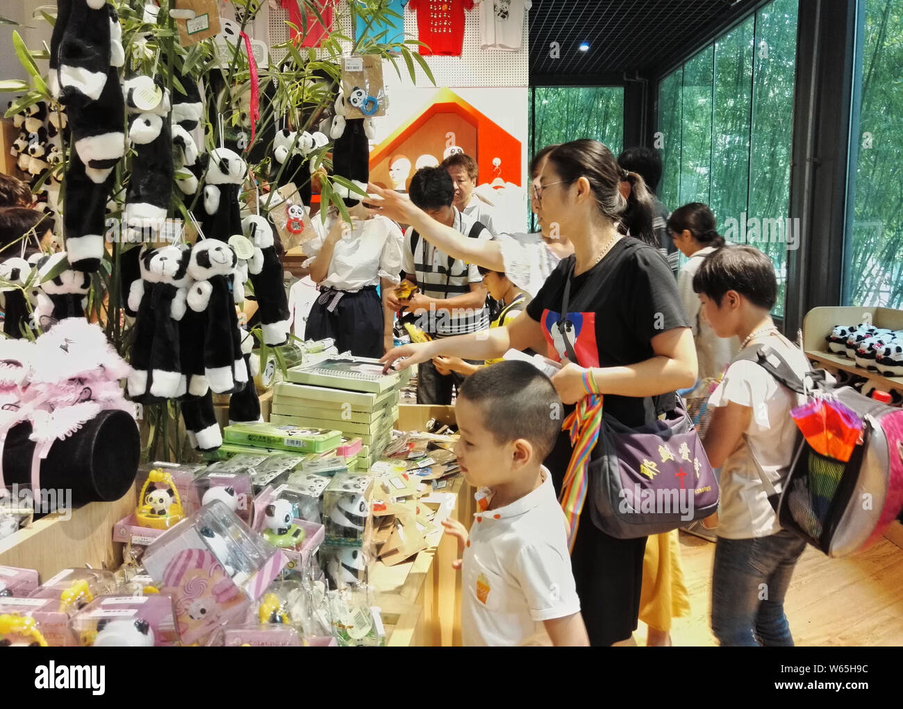Customers choose panda-themed souvenirs at the Giant Panda House Shop ...