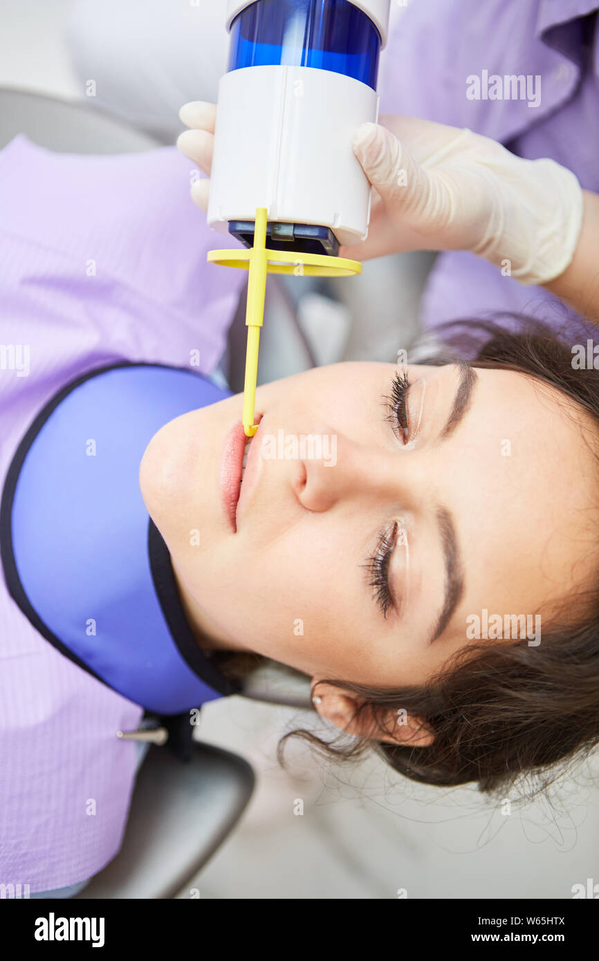 Single tooth of a patient is examined at the dentist with a mobile X ...