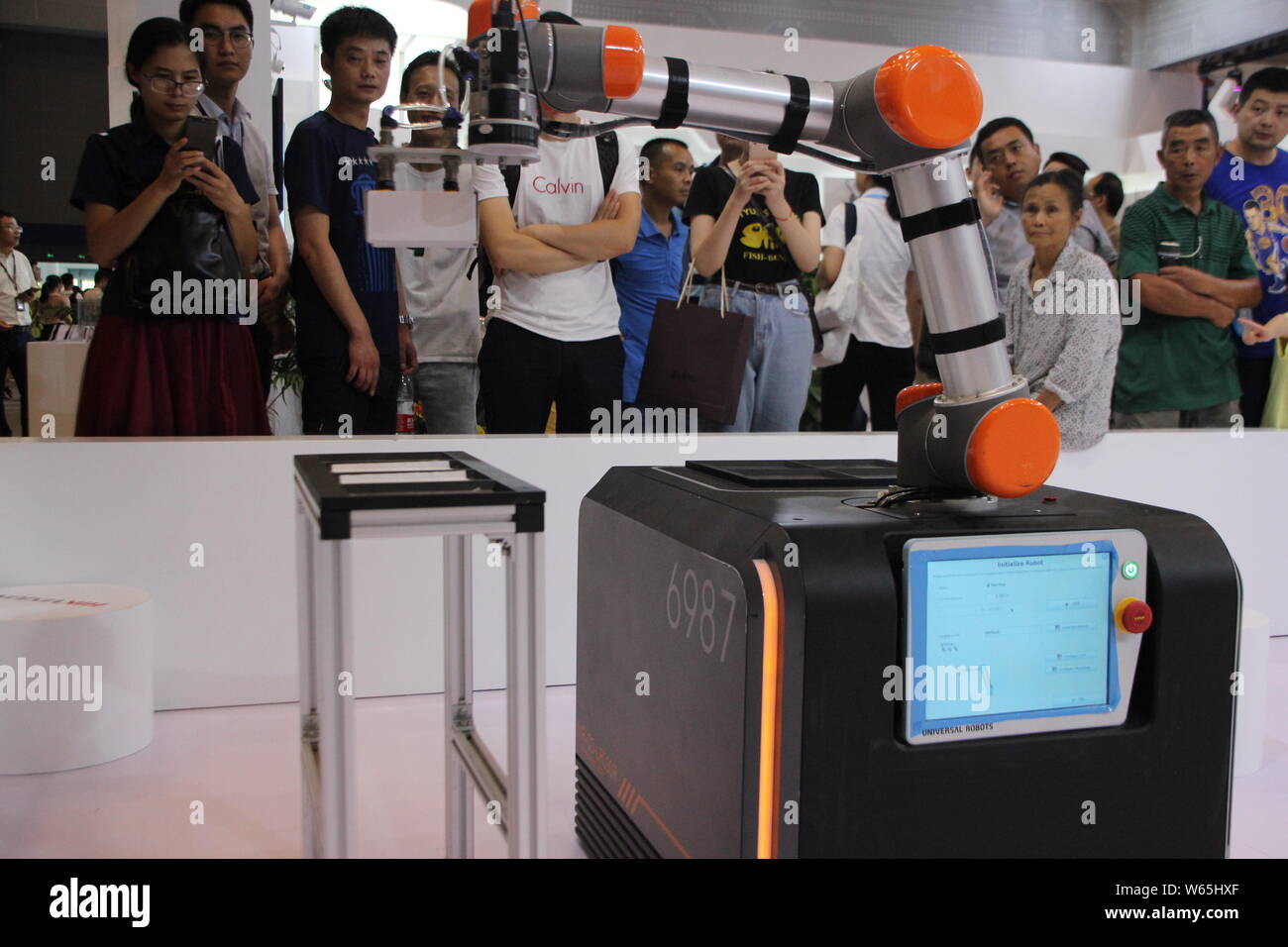 An AI-powered porter robot equipped with a mechanical arm developed by ...