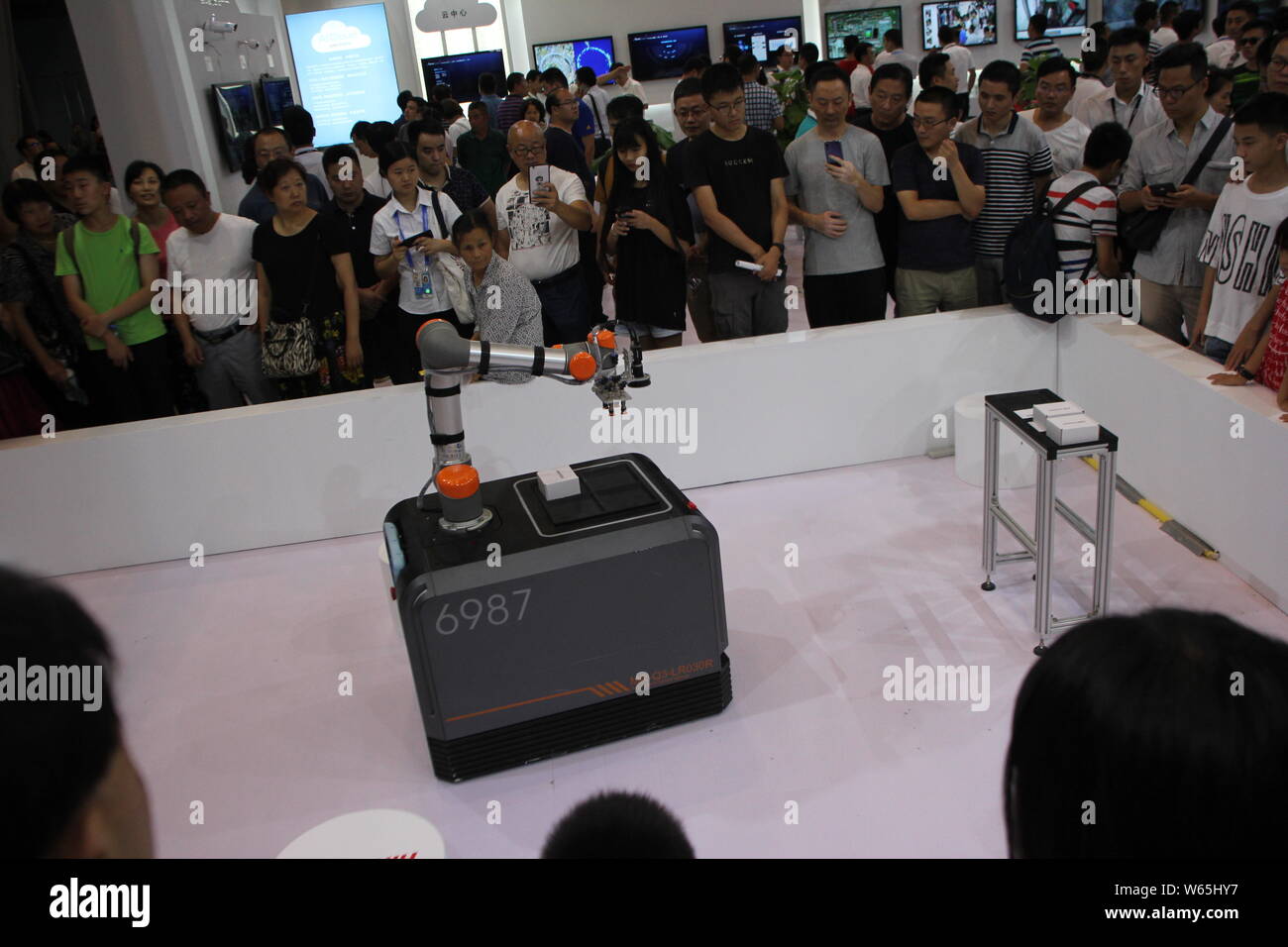 An AI-powered porter robot equipped with a mechanical arm developed by ...