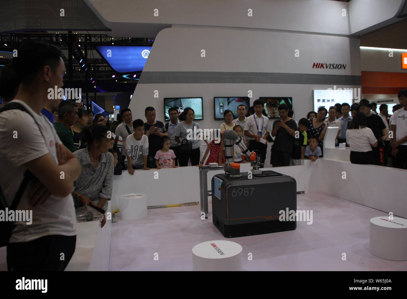 An AI-powered porter robot equipped with a mechanical arm developed by ...