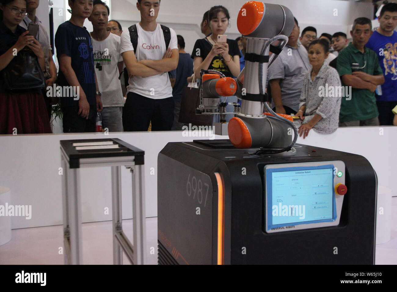 An AI-powered porter robot equipped with a mechanical arm developed by ...