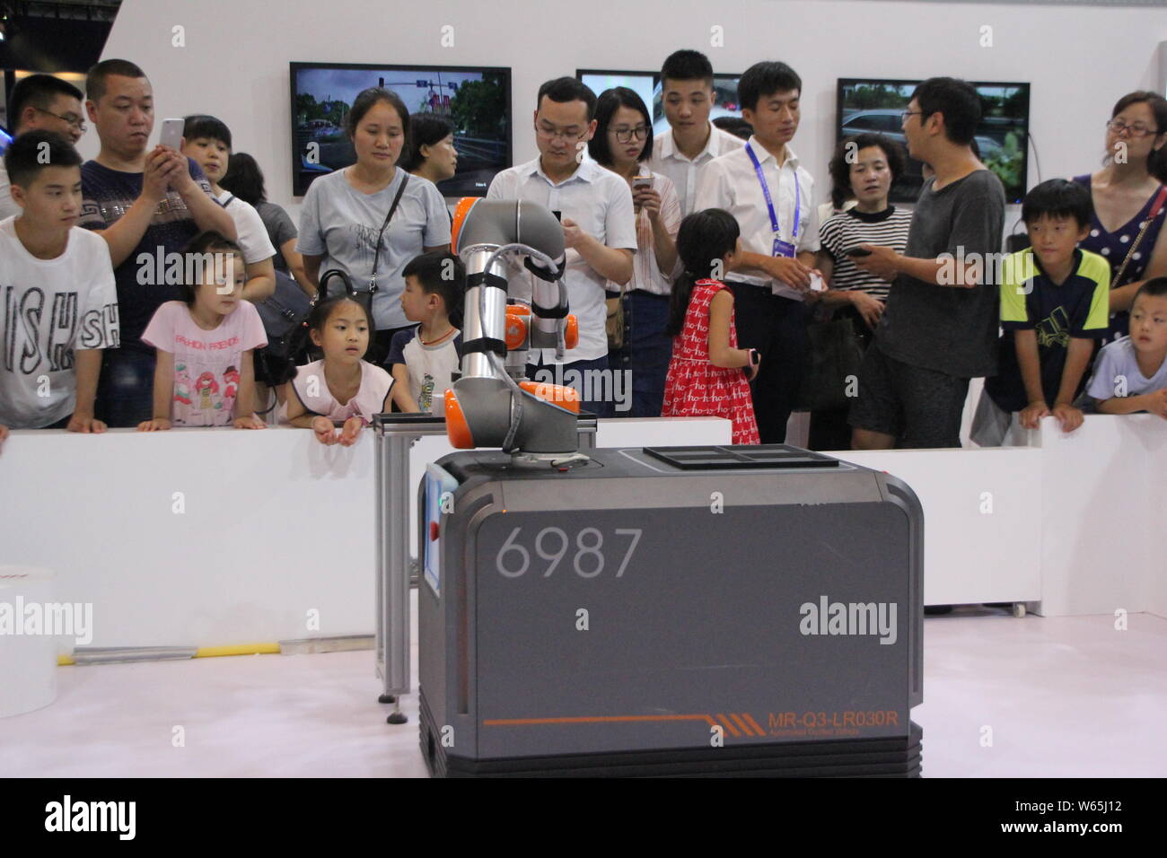 An AI-powered porter robot equipped with a mechanical arm developed by ...