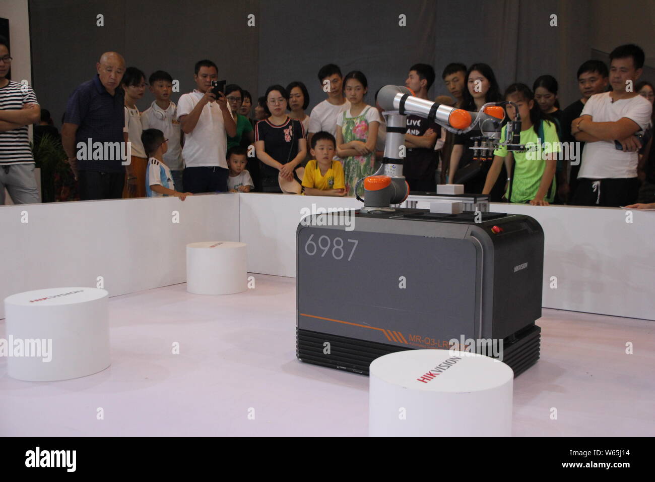 An AI-powered porter robot equipped with a mechanical arm developed by ...