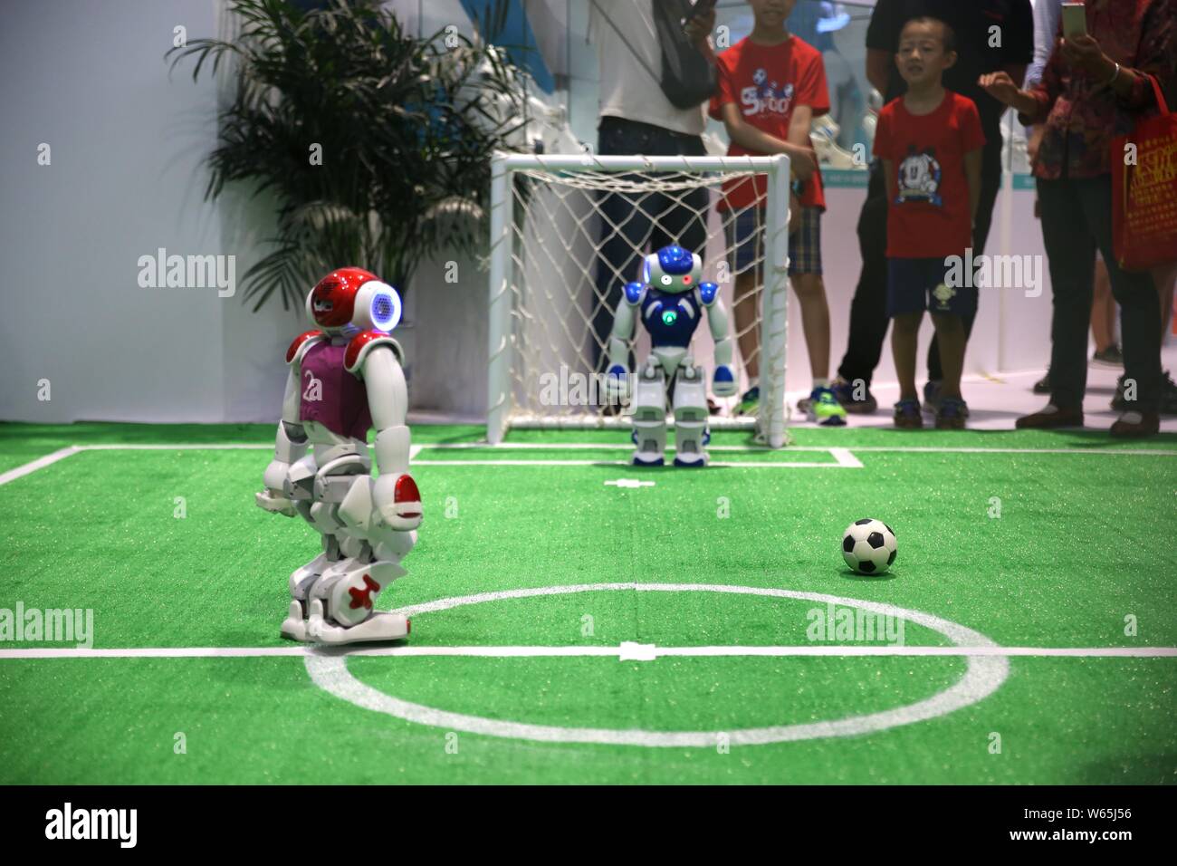 Robots play soccer during the World Robot Conference (WRC) 2018 in ...