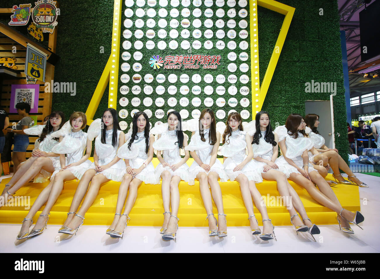 Chinese showgirls pose at the stand of Chinese one game developer and ...