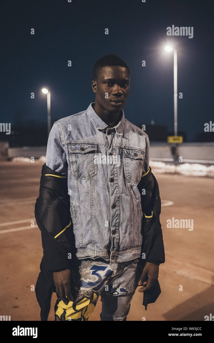 portrait of young black man standing outdoor in parking space – youth ...
