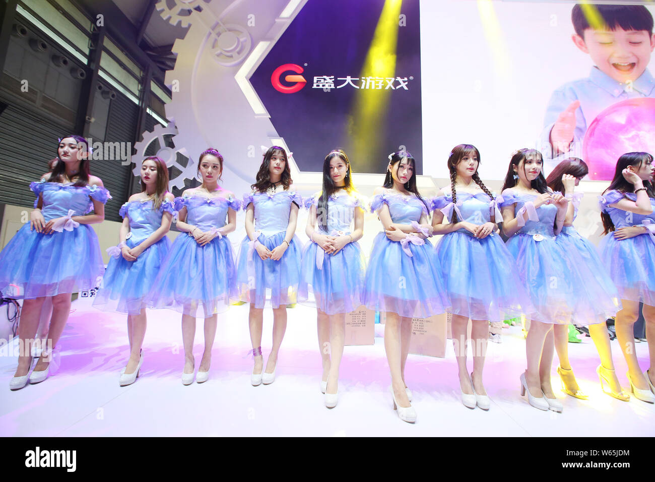Chinese showgirls pose at the stand of Shanda Games during the 16th ...