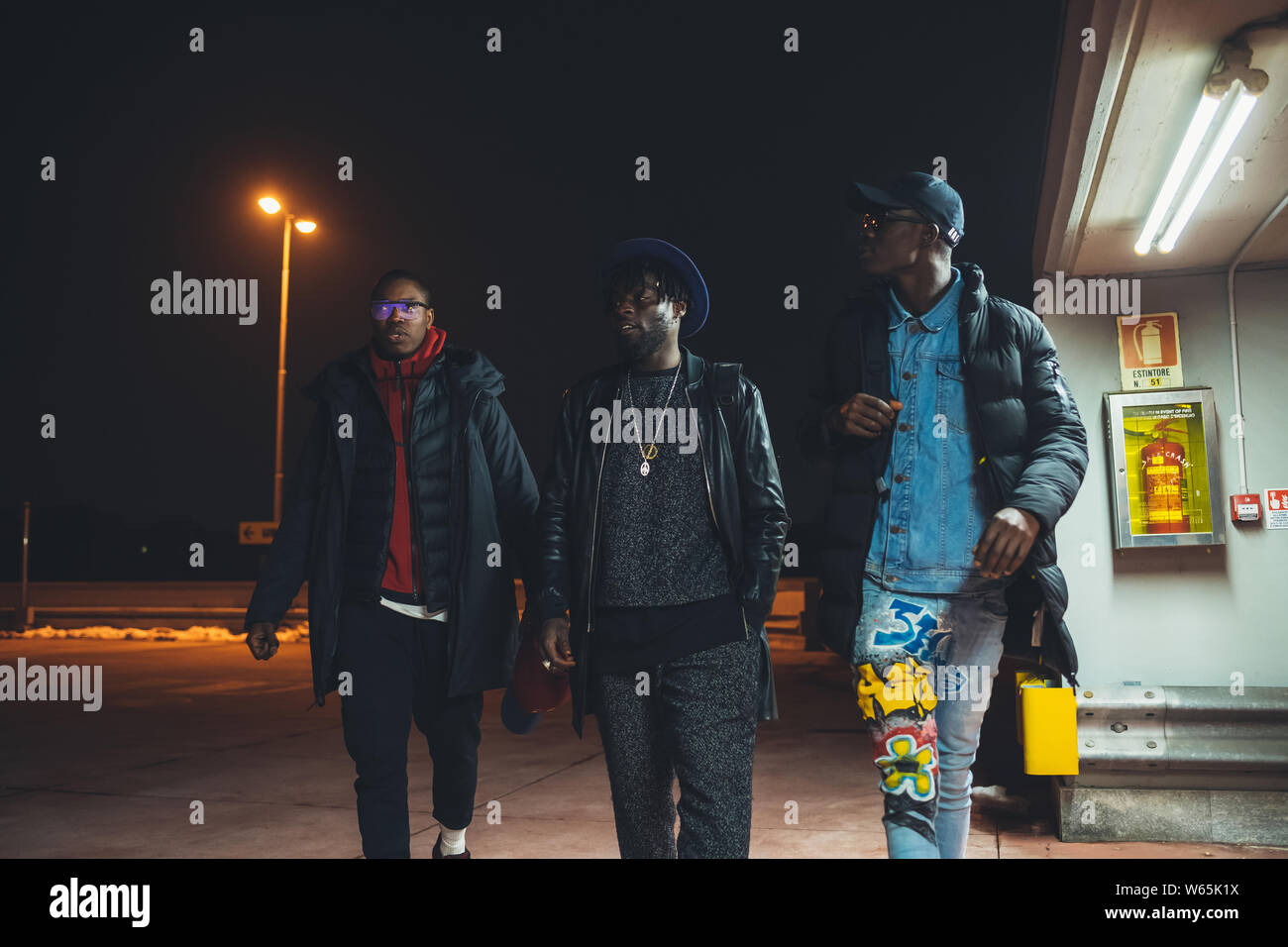 Three young african men walking in the street together – relationship ...