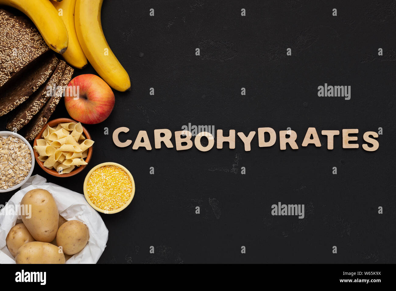 Carbohydrates text with healthy food on black background Stock Photo ...