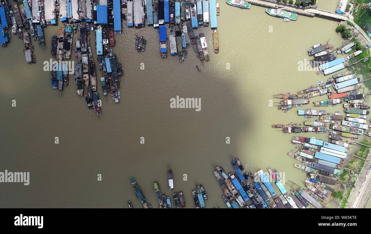 Fishing boats are docked at a harbor in preparation for Typhoon Bebinca ...