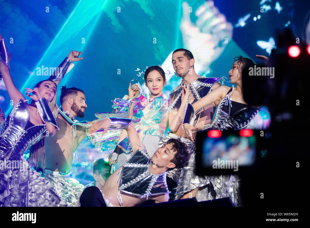 Taiwanese singer and actress Angela Chang, center, performs during her ...