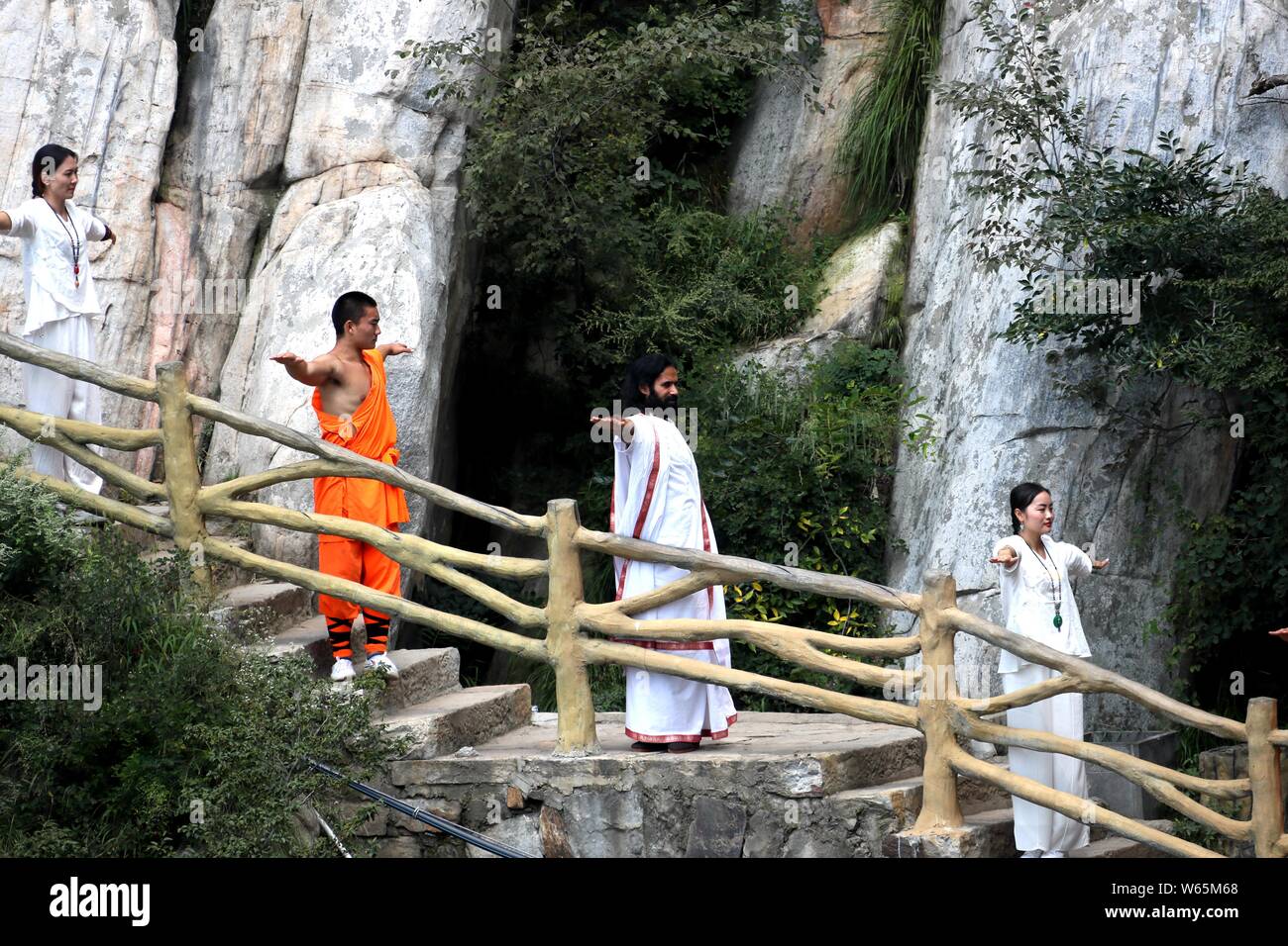 In this aerial view, Yoga lovers practice yoga and Shaolin students ...