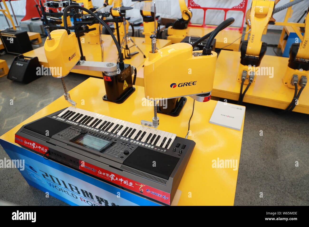 A group of robots play music instruments during the World Robot ...