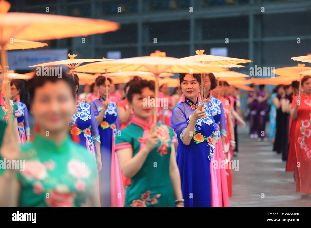Chinese women dressed in cheongsam, also known as qipao in Chinese ...