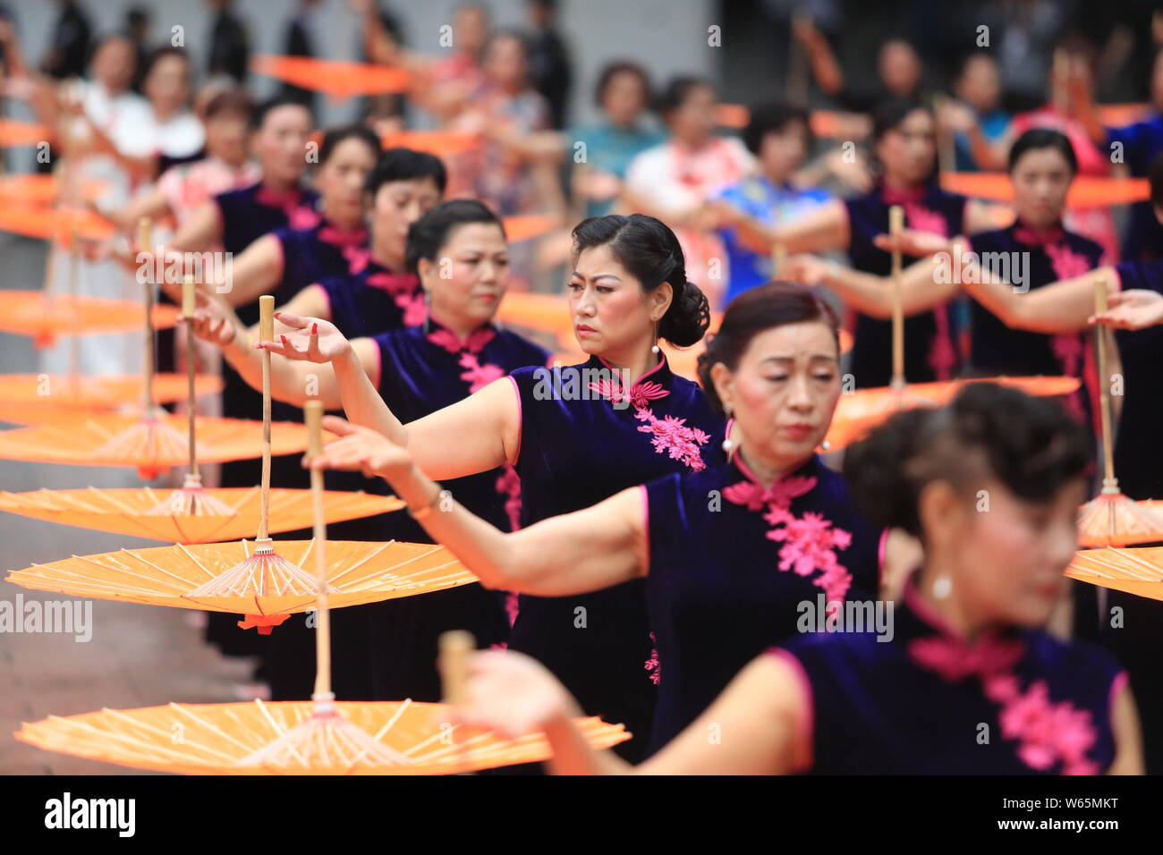 Chinese women dressed in cheongsam, also known as qipao in Chinese ...
