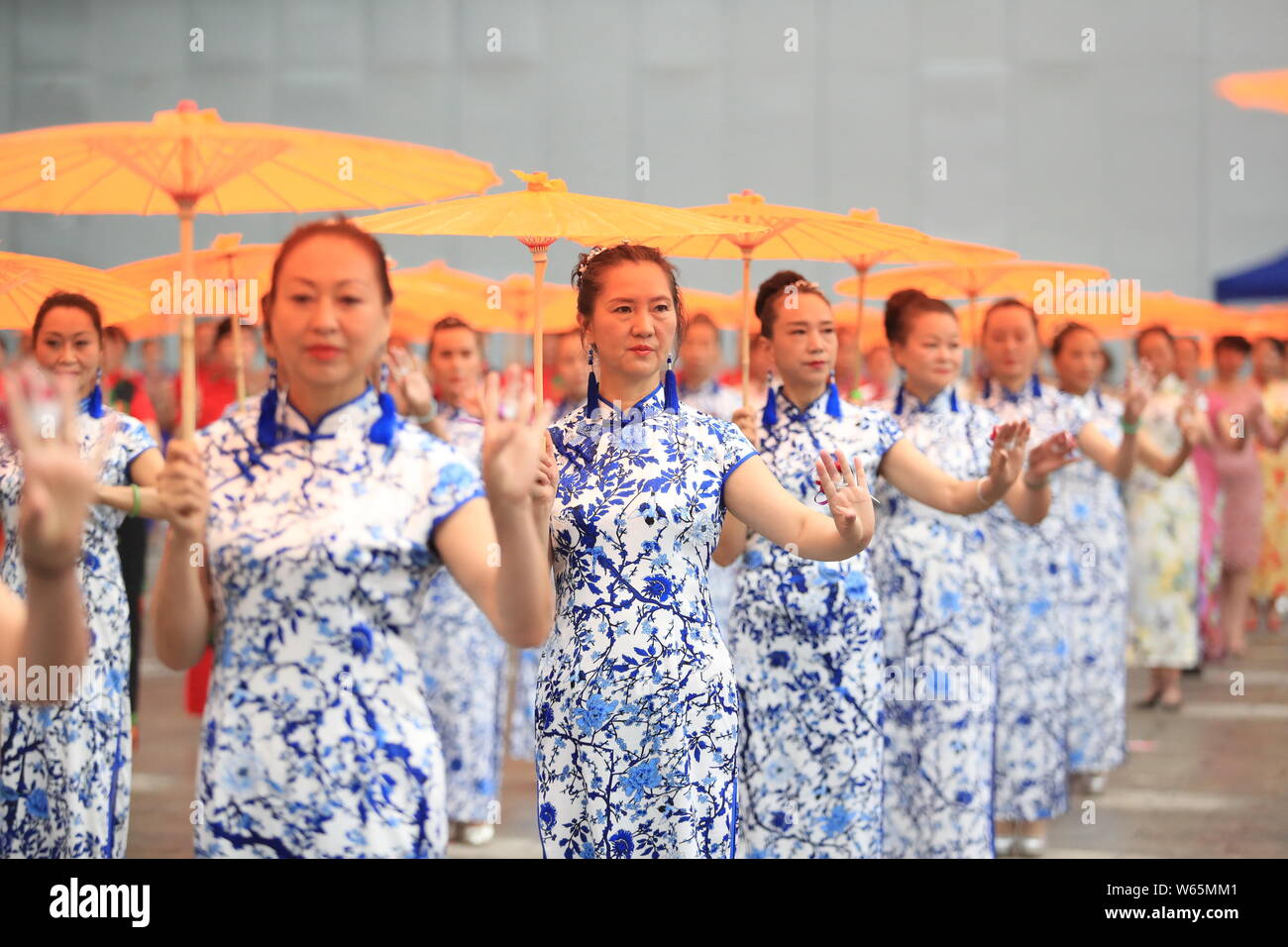 Chinese women dressed in cheongsam, also known as qipao in Chinese ...