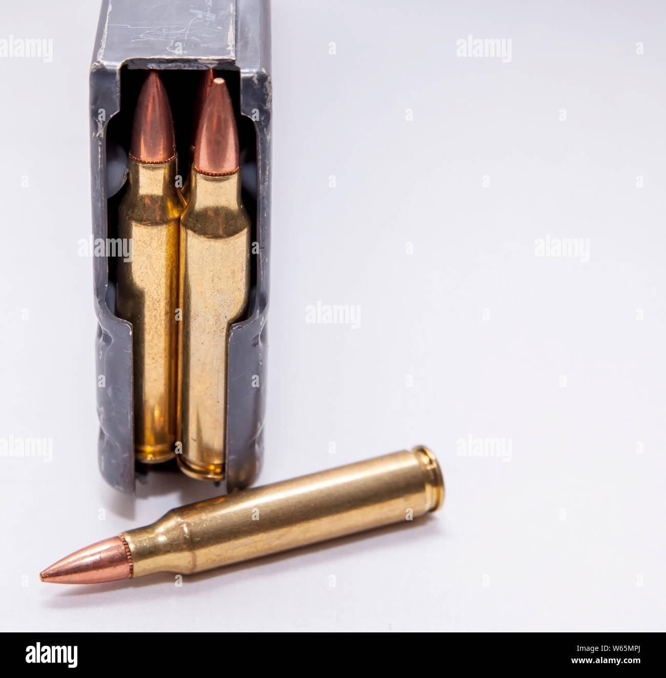 A loaded 223 caliber rifle magazine on a white background with added ...