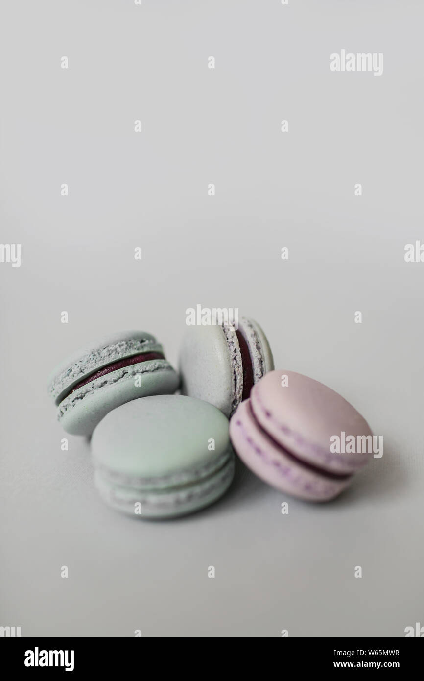 Top view of a pile of sweet macaroon biscuits of pastel color lying on ...