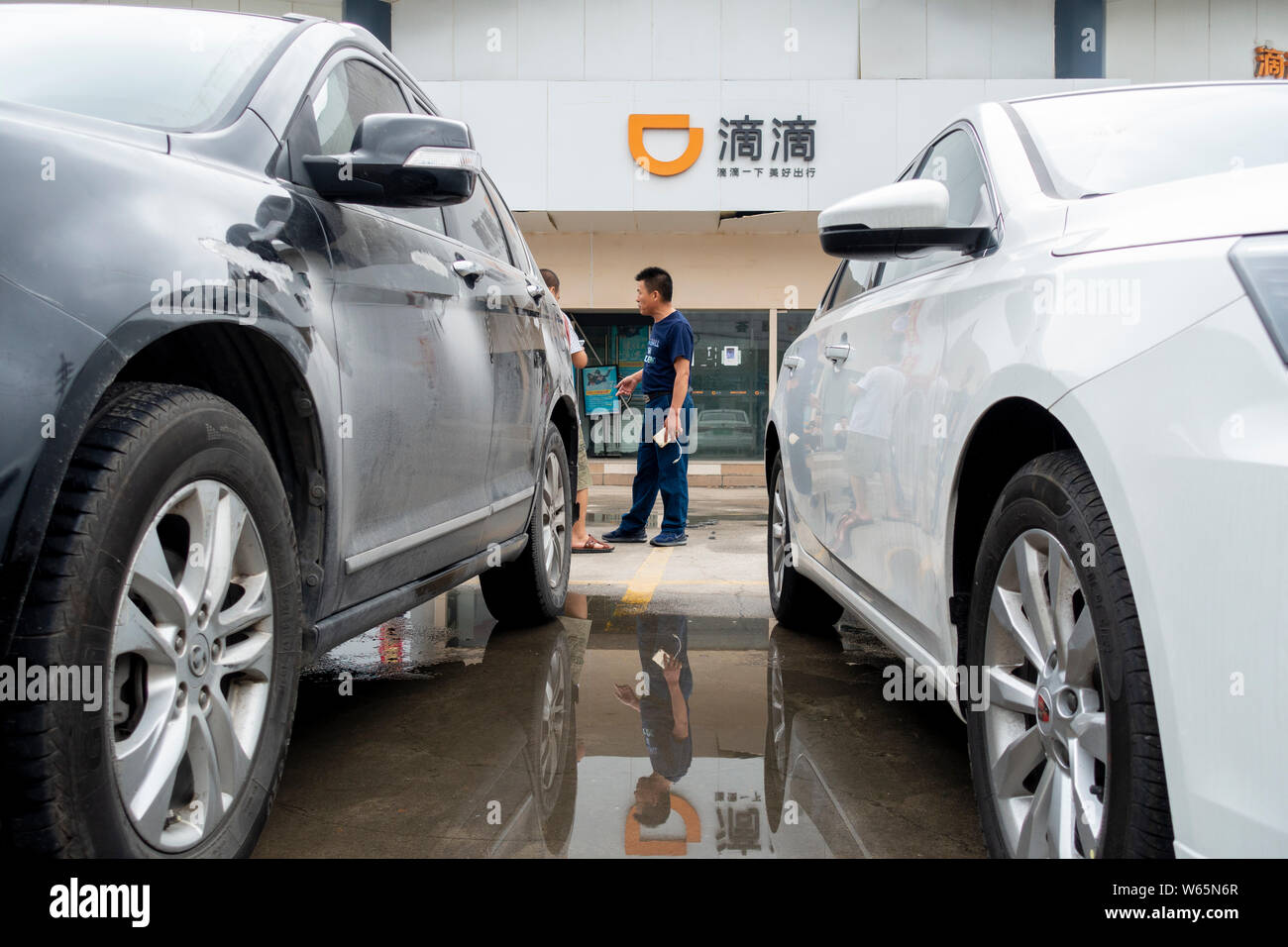 --FILE--Cars are parked in front of a Didi Club of the taxi-hailing and ...