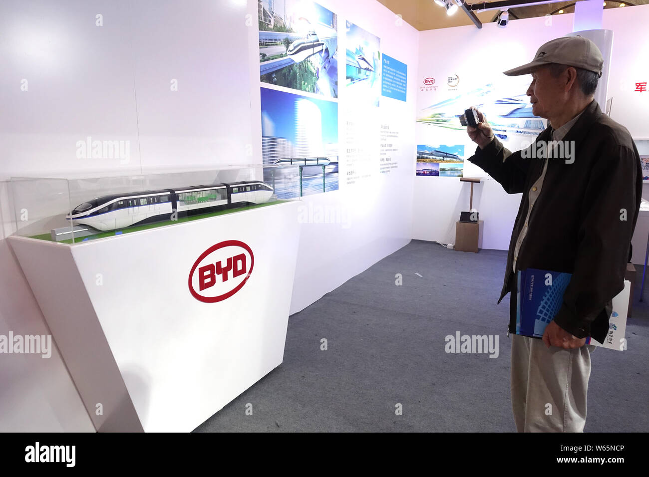 --FILE--A visitor takes photos of a monorail train model dubbed ...