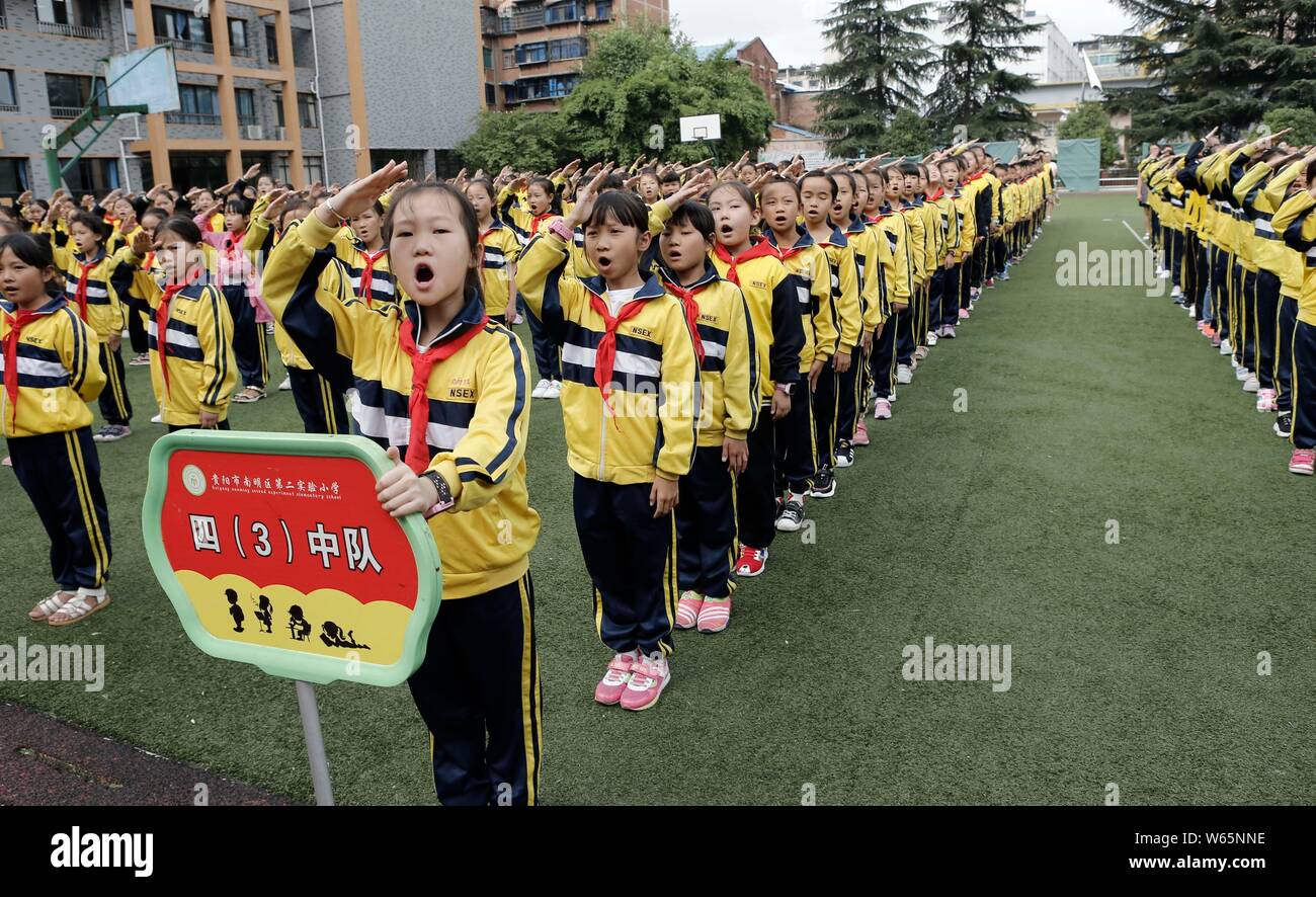 Students attend a flag-raising ceremony of a new semester at a primary ...