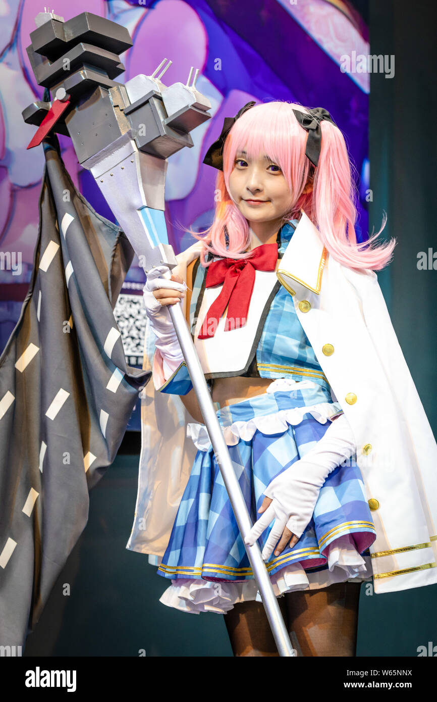 A Chinese showgirl, dressed in cosplay costume, poses during the 16th ...