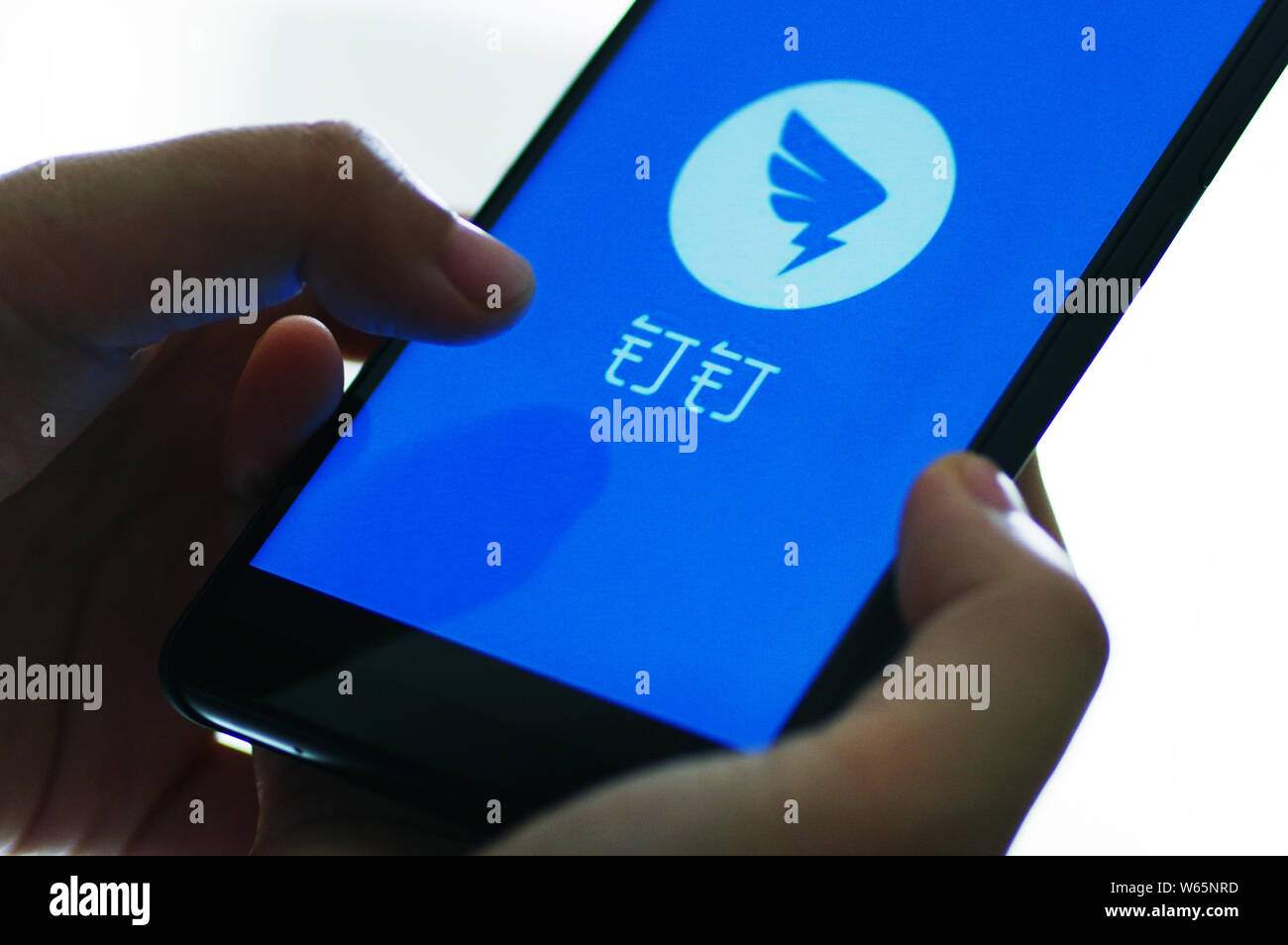 --FILE--A Chinese mobile phone user uses the mobile app of DingTalk ...