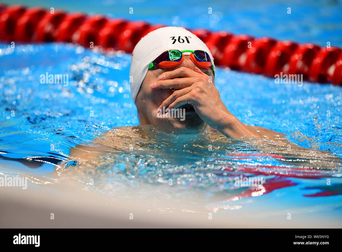 Sun Yang of China sweeps after winning the men's 1500m freestyle final ...