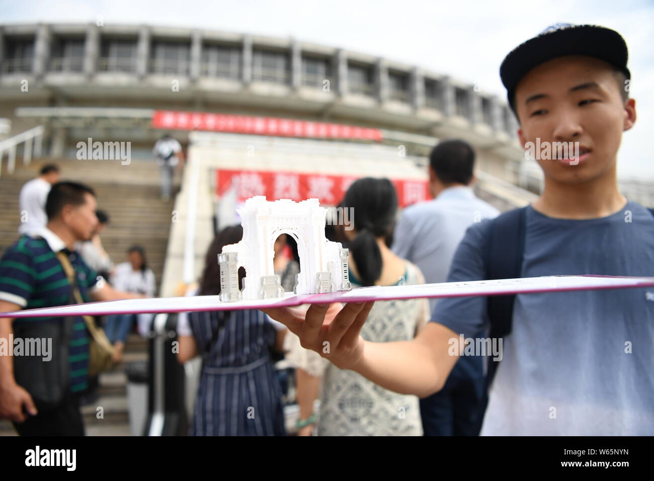 A freshman shows his acceptance letter with a 3D paper sculpture of the ...