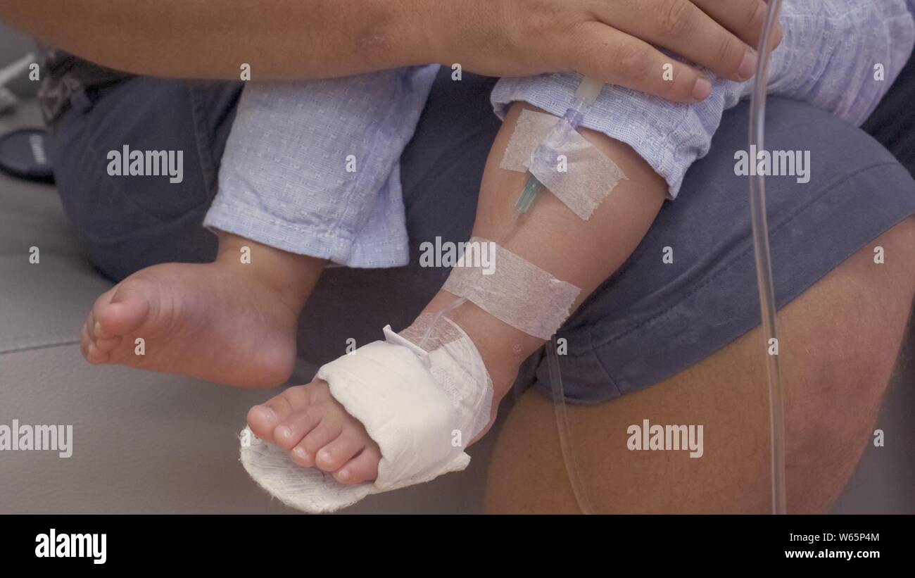 Surviving sad Dad and crying little daughter in hospital. Little girl ...