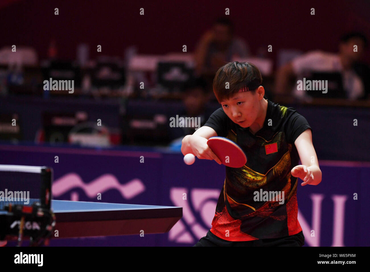 Wang Manyu of China returns a shot to Kim Nam-hae of North Korea in the ...