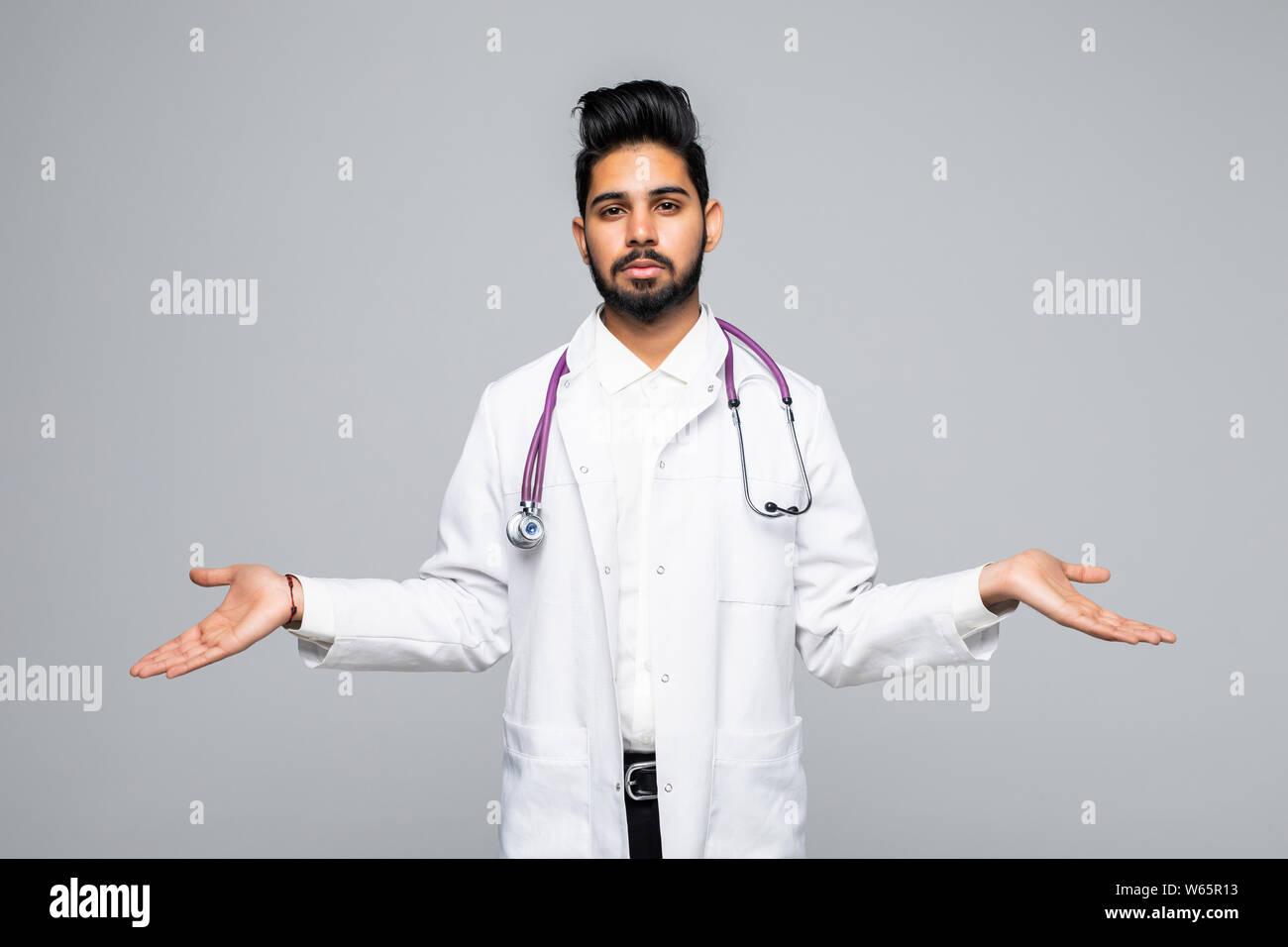 Confused indian male doctor making asking question gesture with hand ...