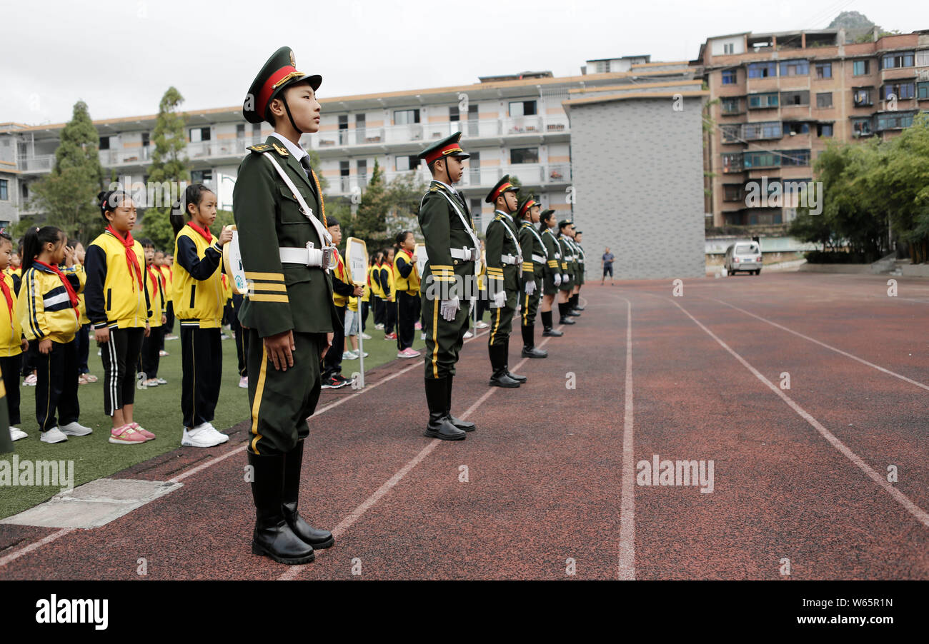 Students attend a flag-raising ceremony of a new semester at a primary ...